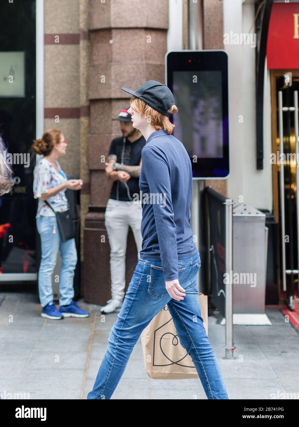 Street Photography: Boy with Cap Walking in the center of London Stock ...