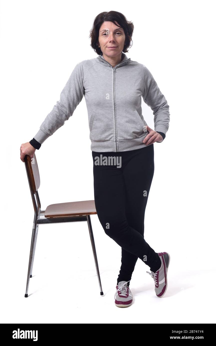 woman standing with a chair in white background Stock Photo - Alamy