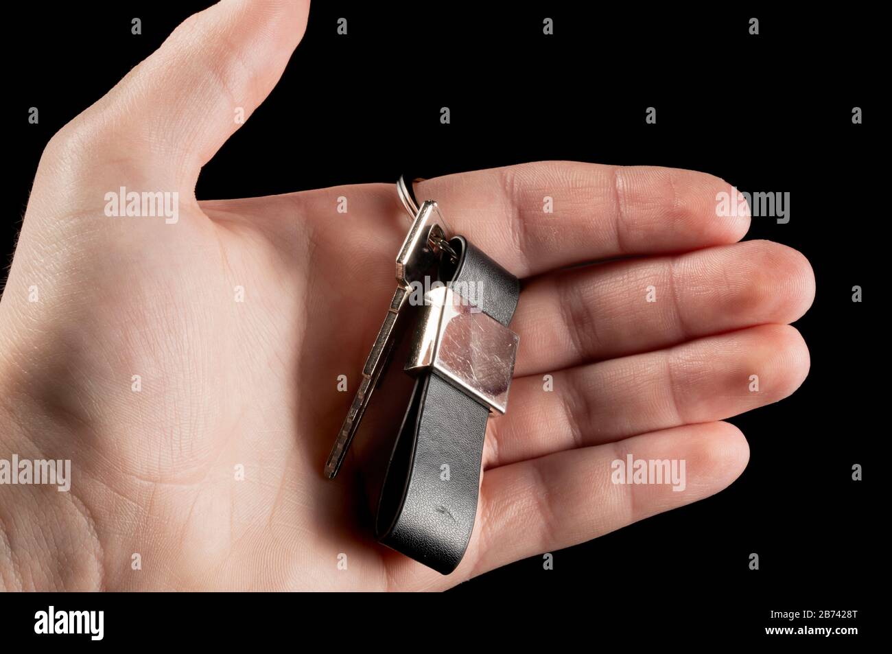Man hand holding keys with keyring for motorbike Stock Photo - Alamy