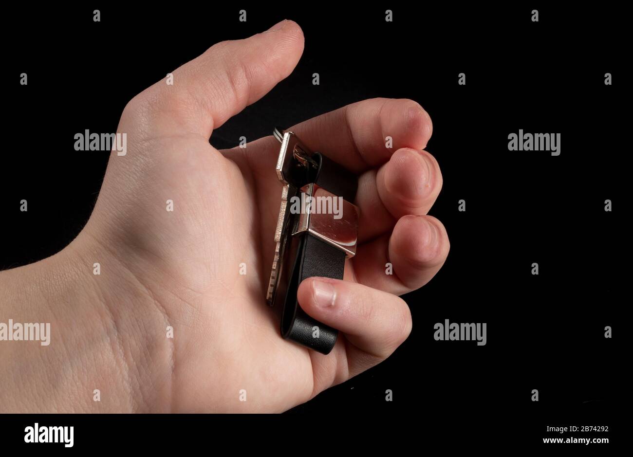 Man hand holding keys with keyring for motorbike Stock Photo - Alamy