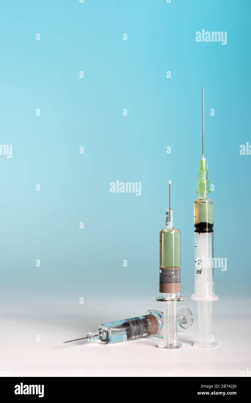 A large and two small syringes for flu vaccination Stock Photo - Alamy