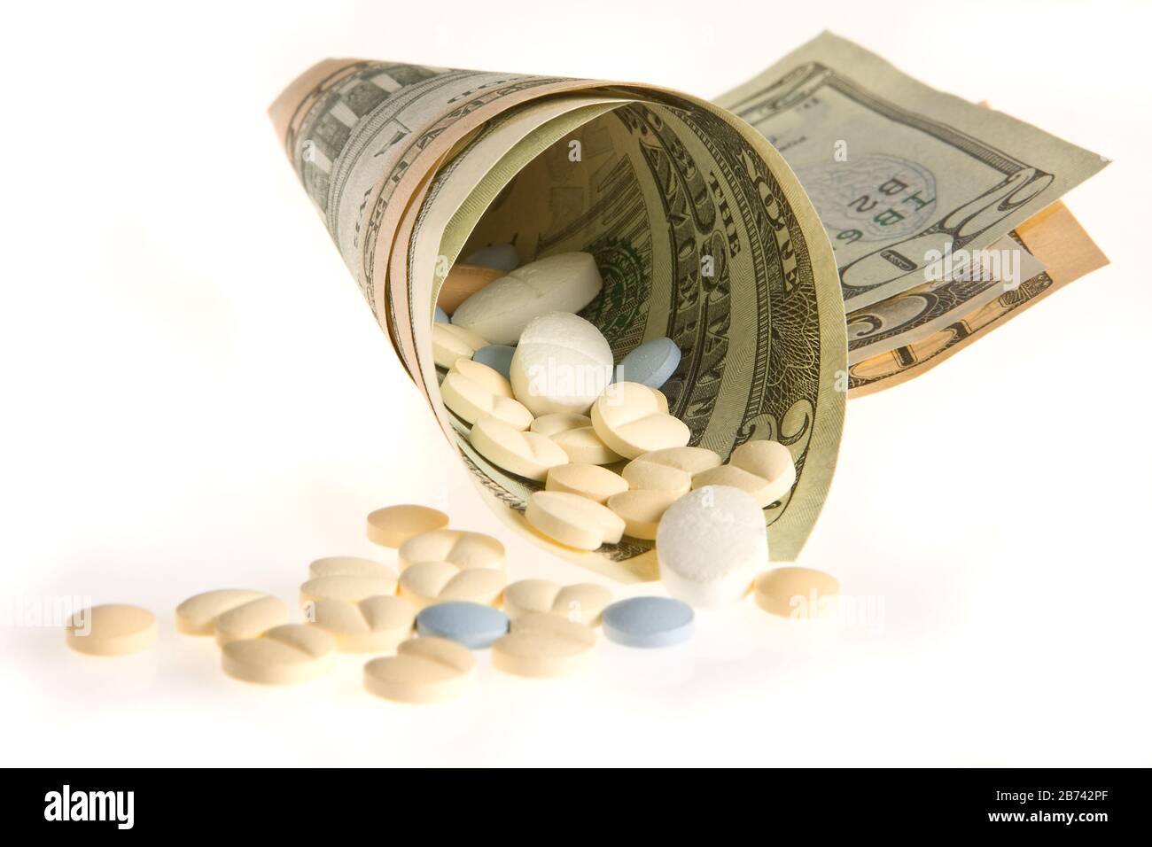 Little pills coming out of a roll of dollar notes Stock Photo - Alamy