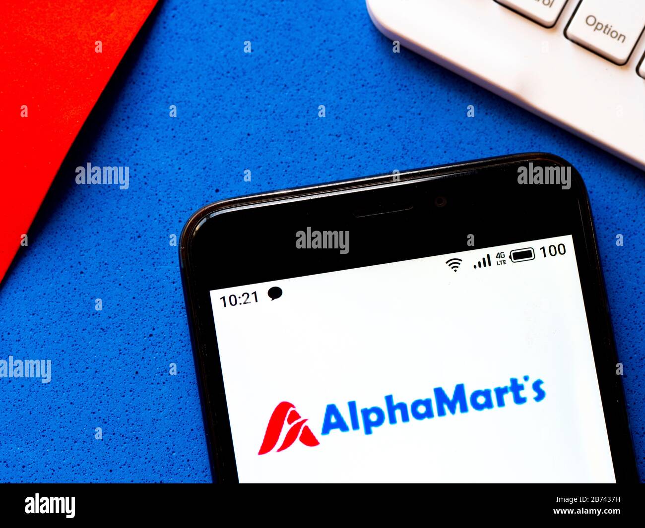 In this photo illustration an AlphaMart’s logo seen displayed on a ...