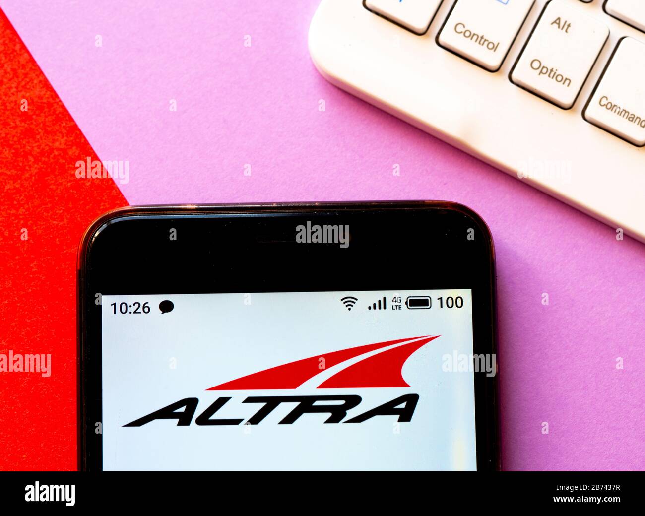 In this photo illustration an Altra logo seen displayed on a smartphone ...
