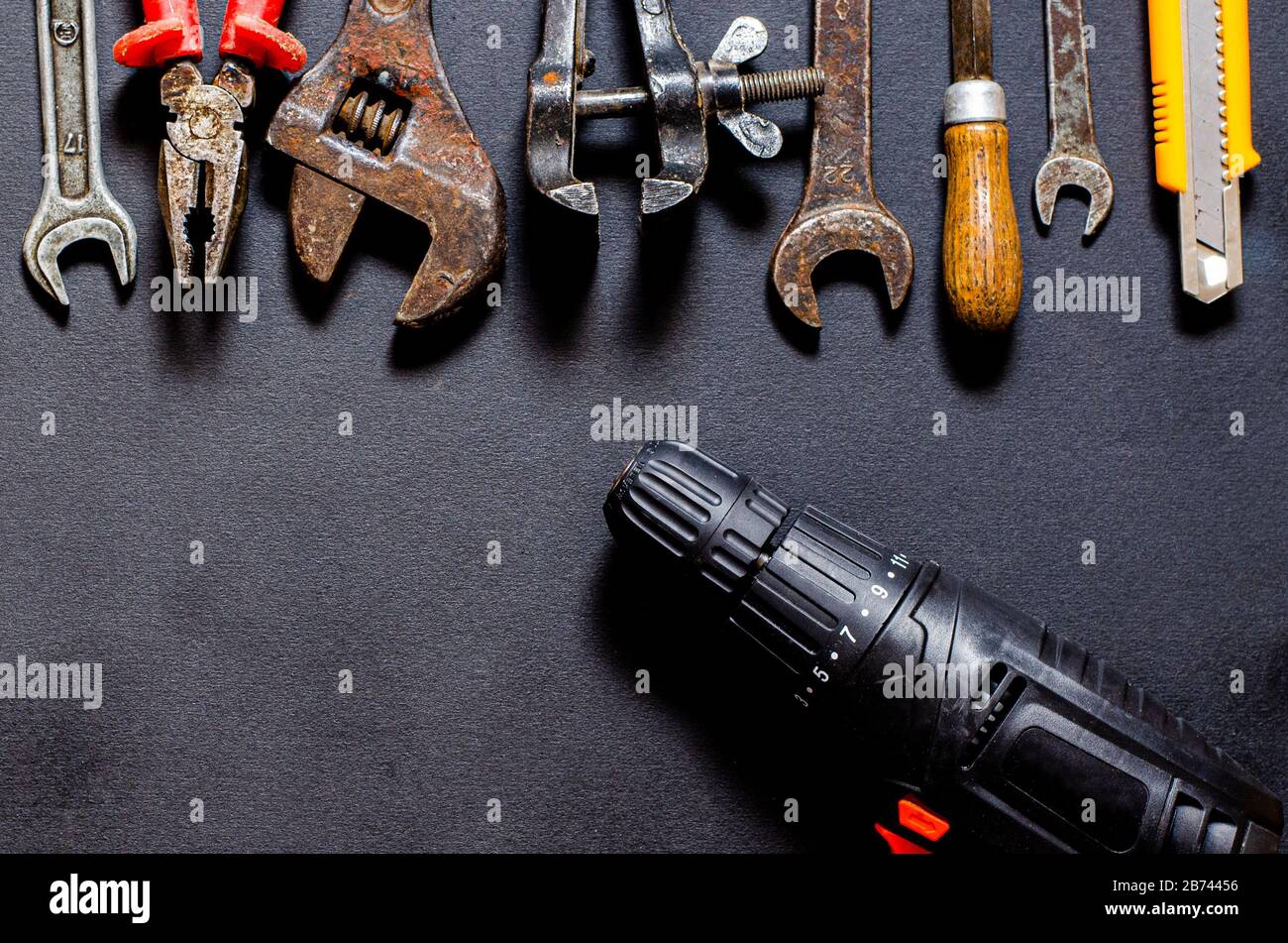 Tools for repair and reconstruction in home conditions lie on a black ...