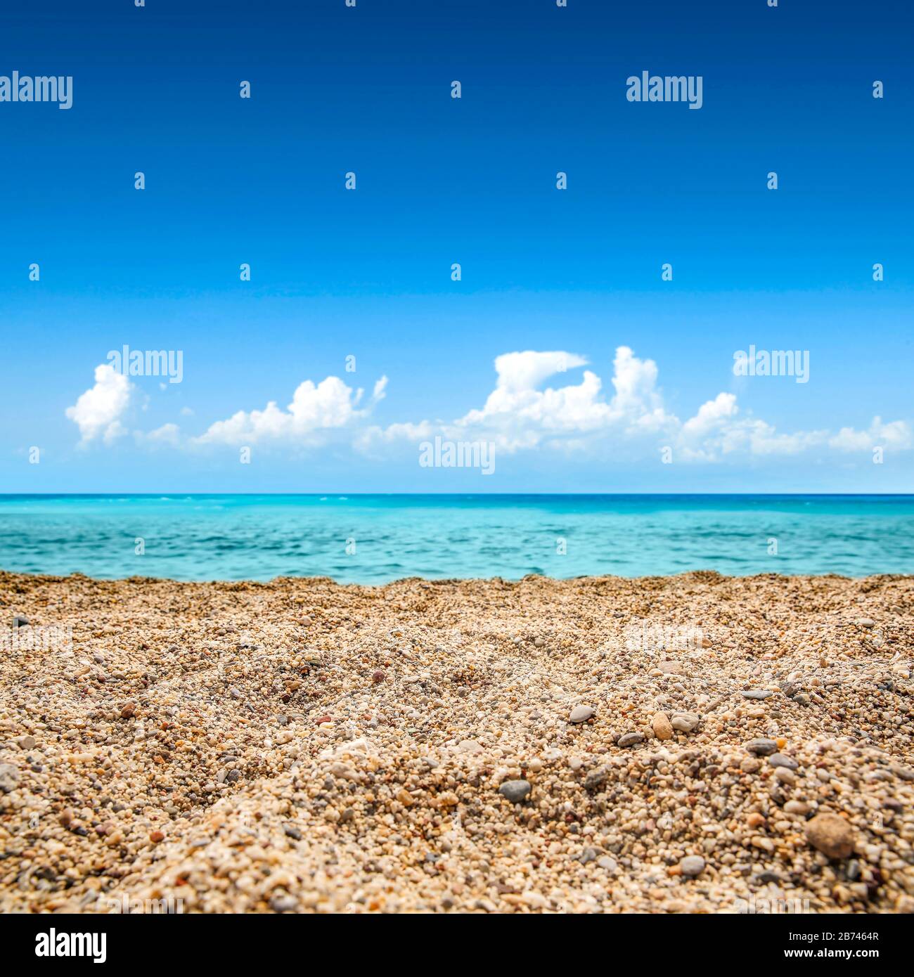 Sunny sandy beach in summer time with sea and blue sky background Stock ...