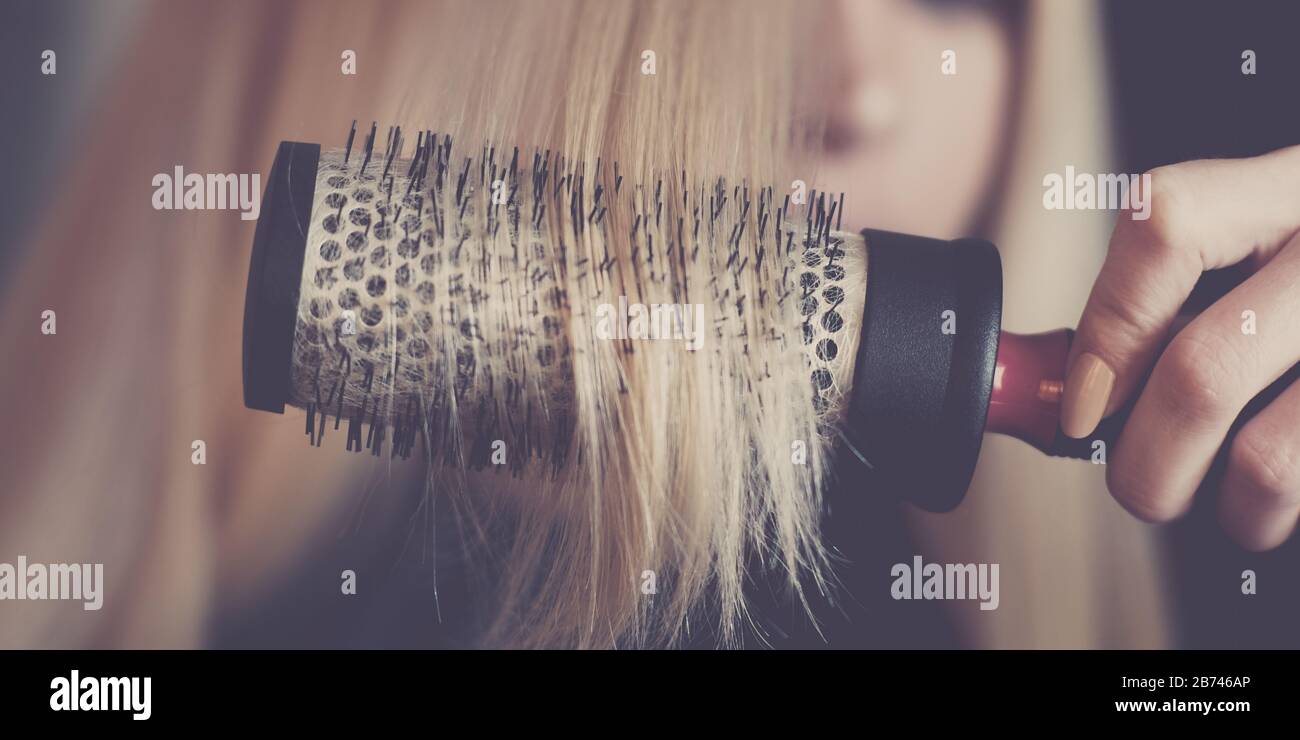 Round brushing combs long blond hair closeup Stock Photo - Alamy