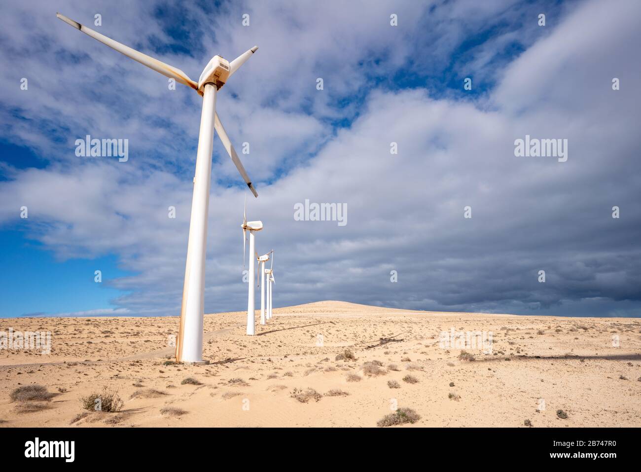 wind turbine in the desert with blue sky background. wind mill farm in ...