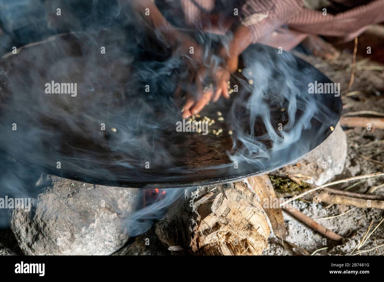 Roasting coffee on a pan over an open fire, Simien Mountains, Ethiopia ...