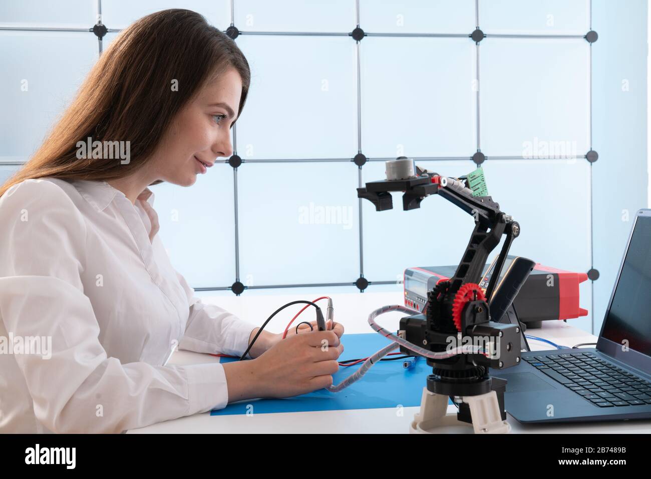 Woman student with robot model arm in university laboratory Stock Photo ...