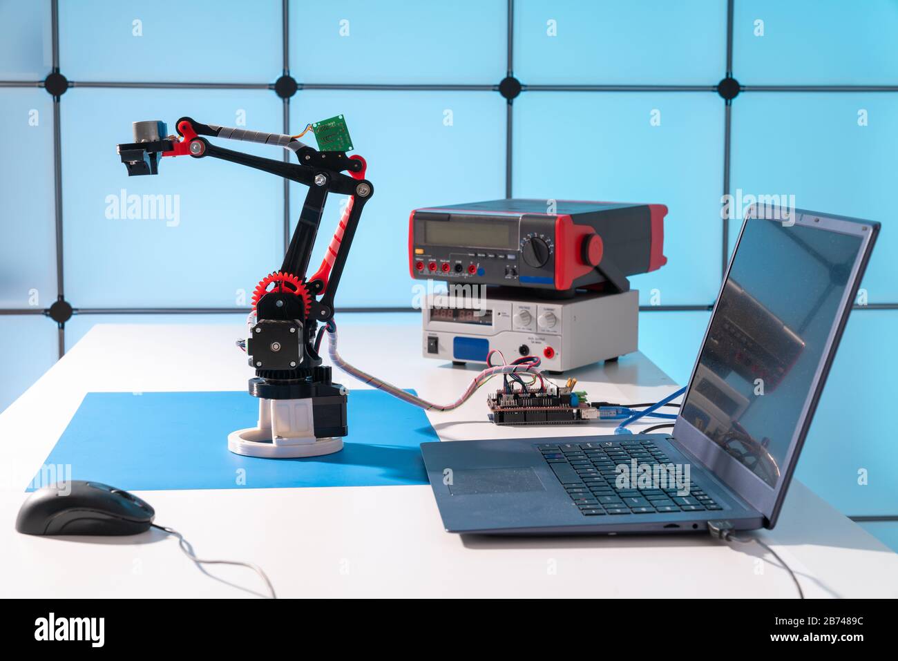 Model of a robot and a laptop on a table in a design office Stock Photo ...