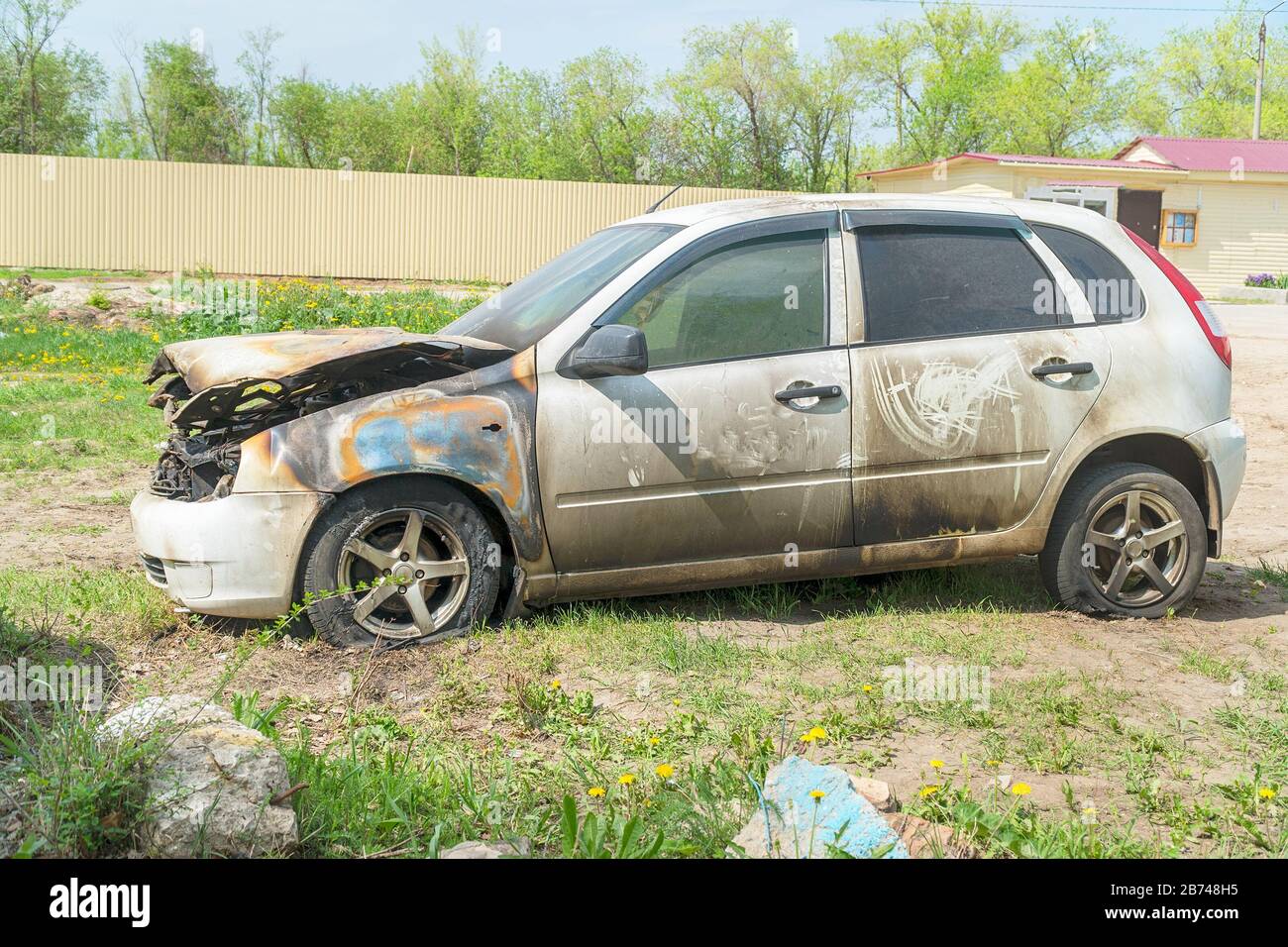 Burnt car on the street. Side view Stock Photo - Alamy
