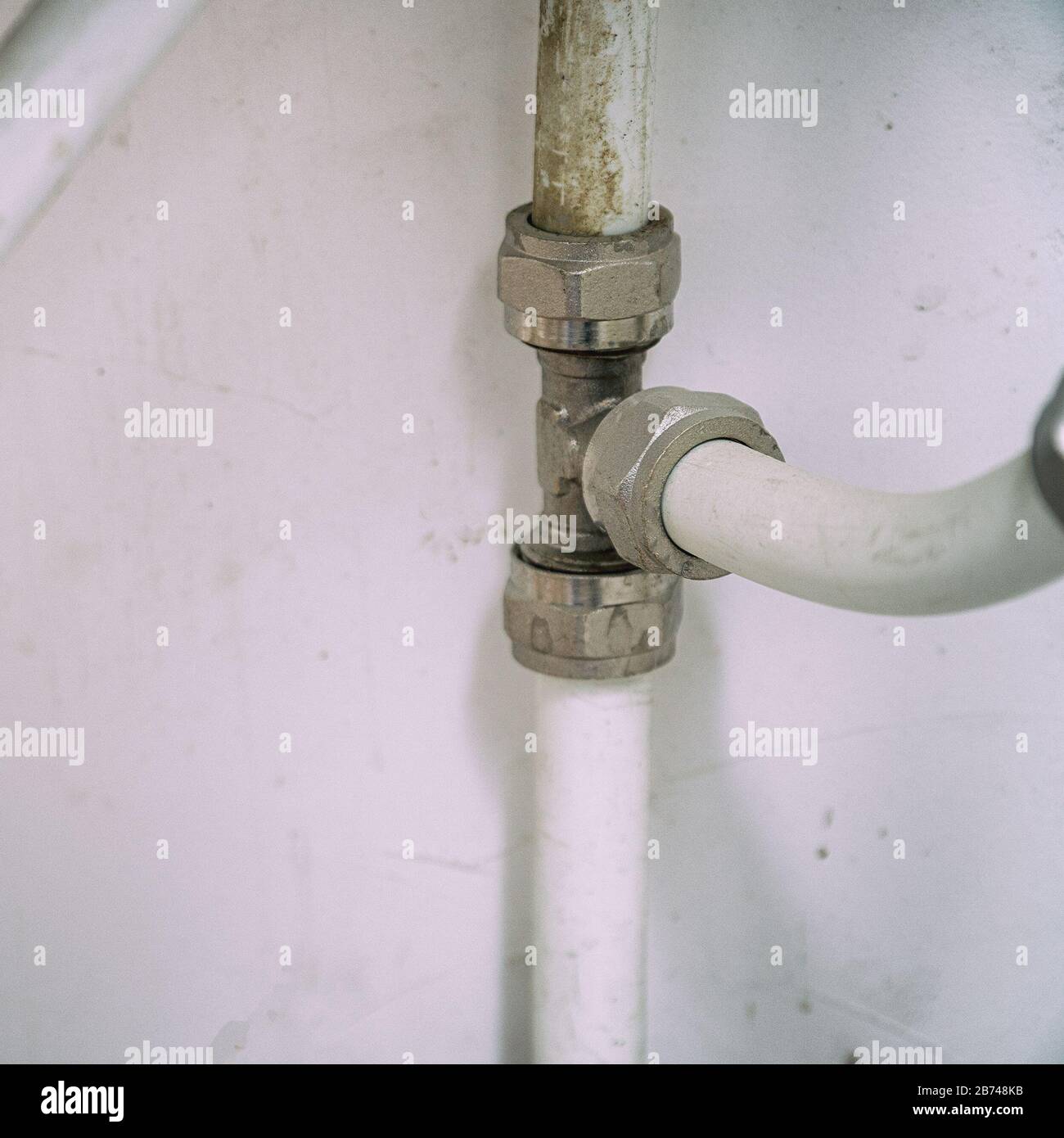 Old connection fitting tee on plastic water pipes Stock Photo - Alamy