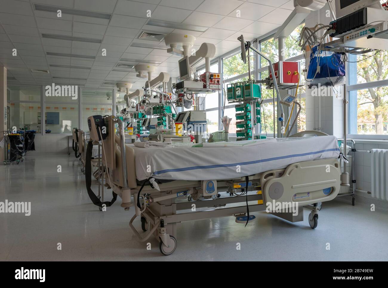 Intensive care unit in hospital, beds with monitors an ventilators, a ...