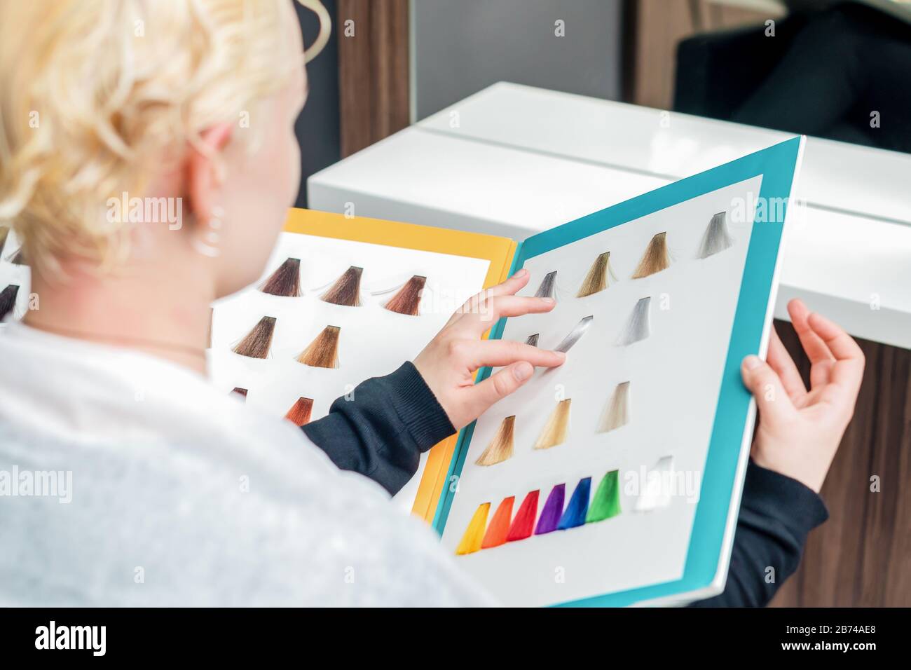 Woman selects hair color from color palette in beauty salon Stock Photo ...