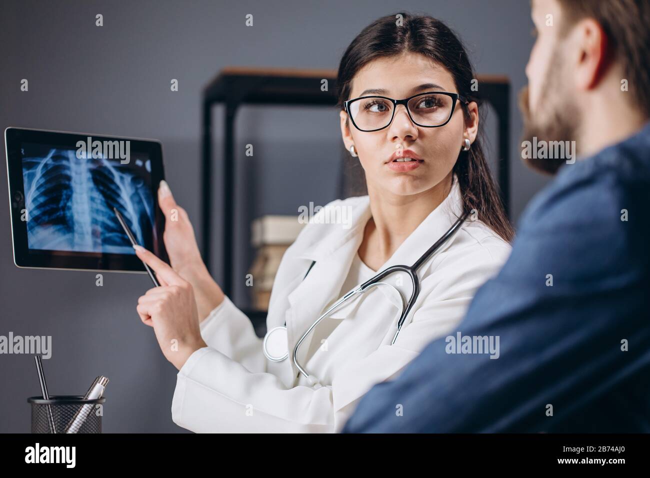 Young Pretty Female MD Using a Tablet Stock Photo - Alamy