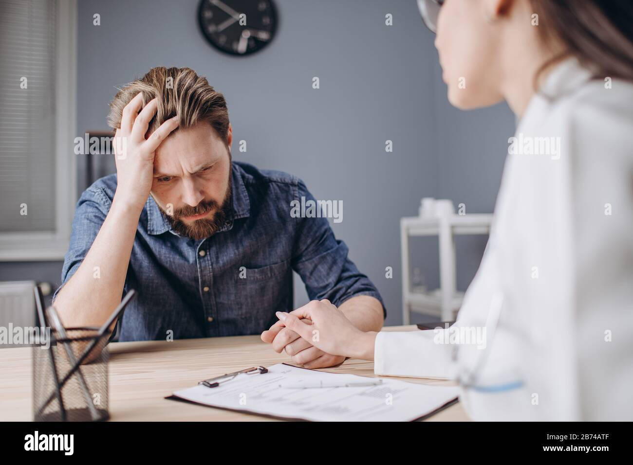 Careful Female Doctor Comforting Upset Bearded Patient Stock Photo - Alamy