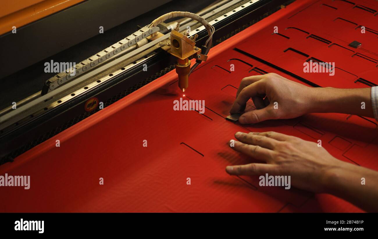 Laser cutting beam high precision on a paperboard. Modern machine ...