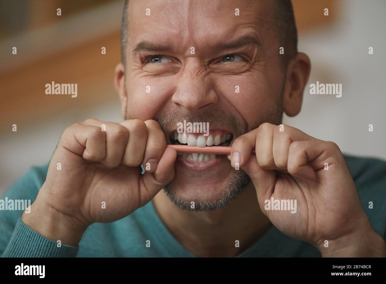 Pencil in mouth hi-res stock photography and images - Alamy