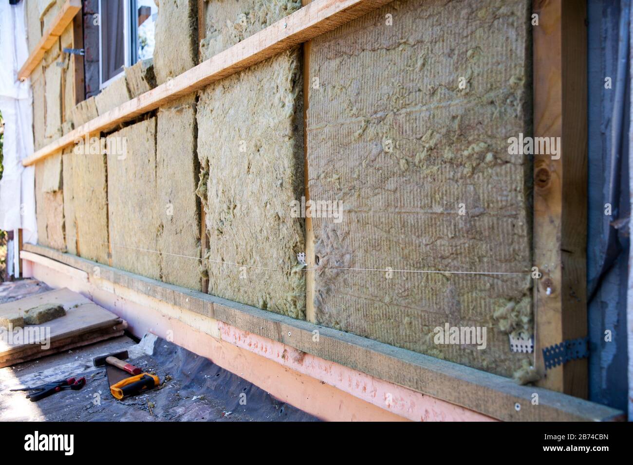 warming the walls of a stone house with a stone wool heater. Ecological ...