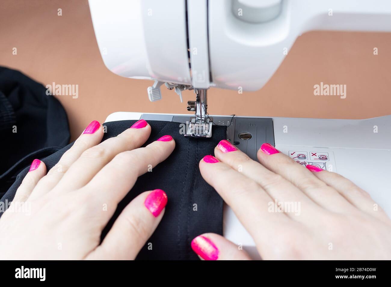 the process of tailoring, woman's hands with a cloth on the sewing ...
