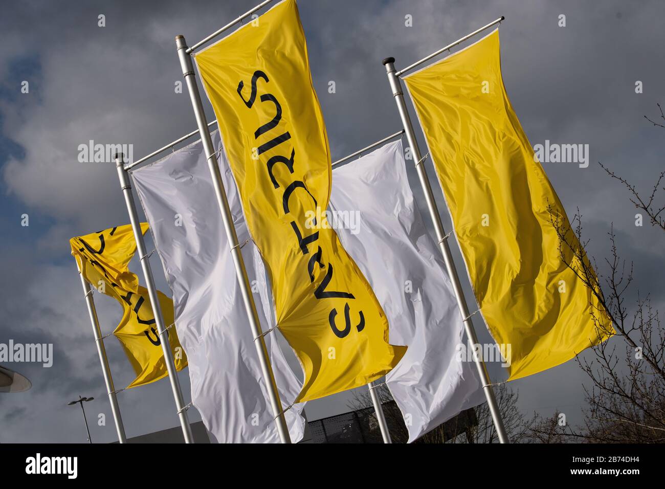 Flags with the new company logo of Sartorius AG blow in the wind ...