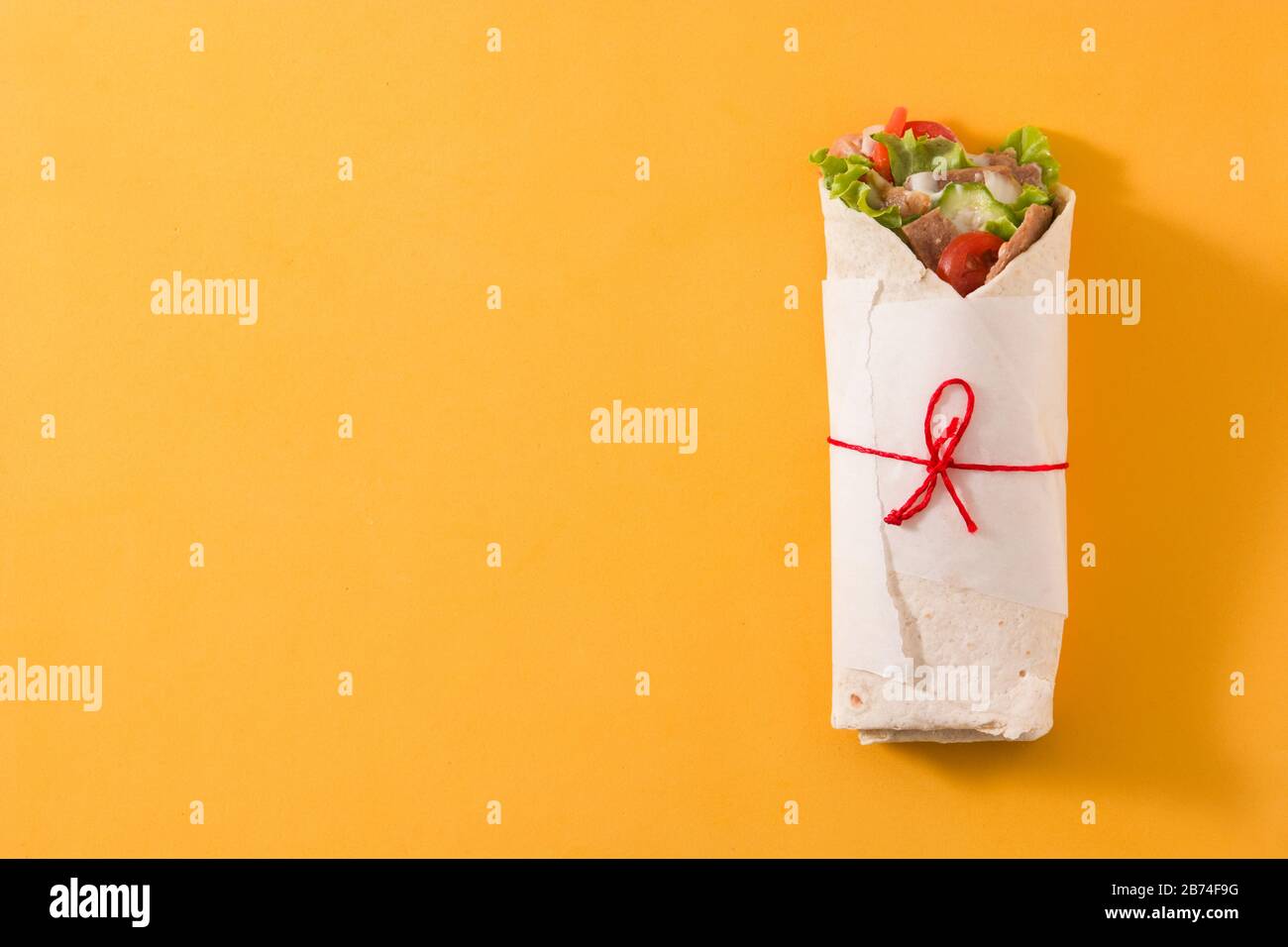 Doner kebab or shawarma sandwich isolated on yellow background. Top ...