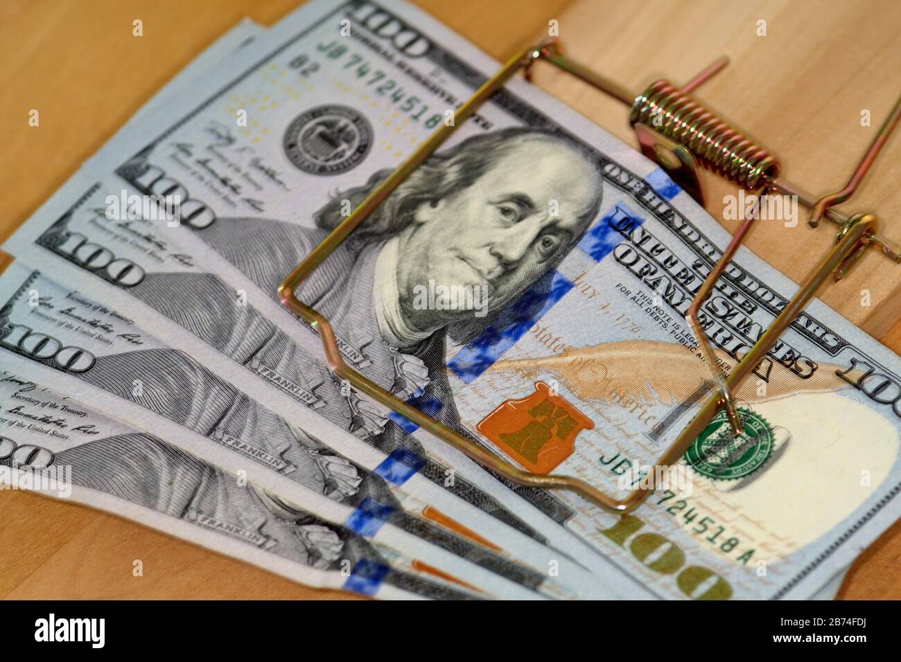 hundred dollar us banknotesnotes trapped in mousetrap Stock Photo - Alamy