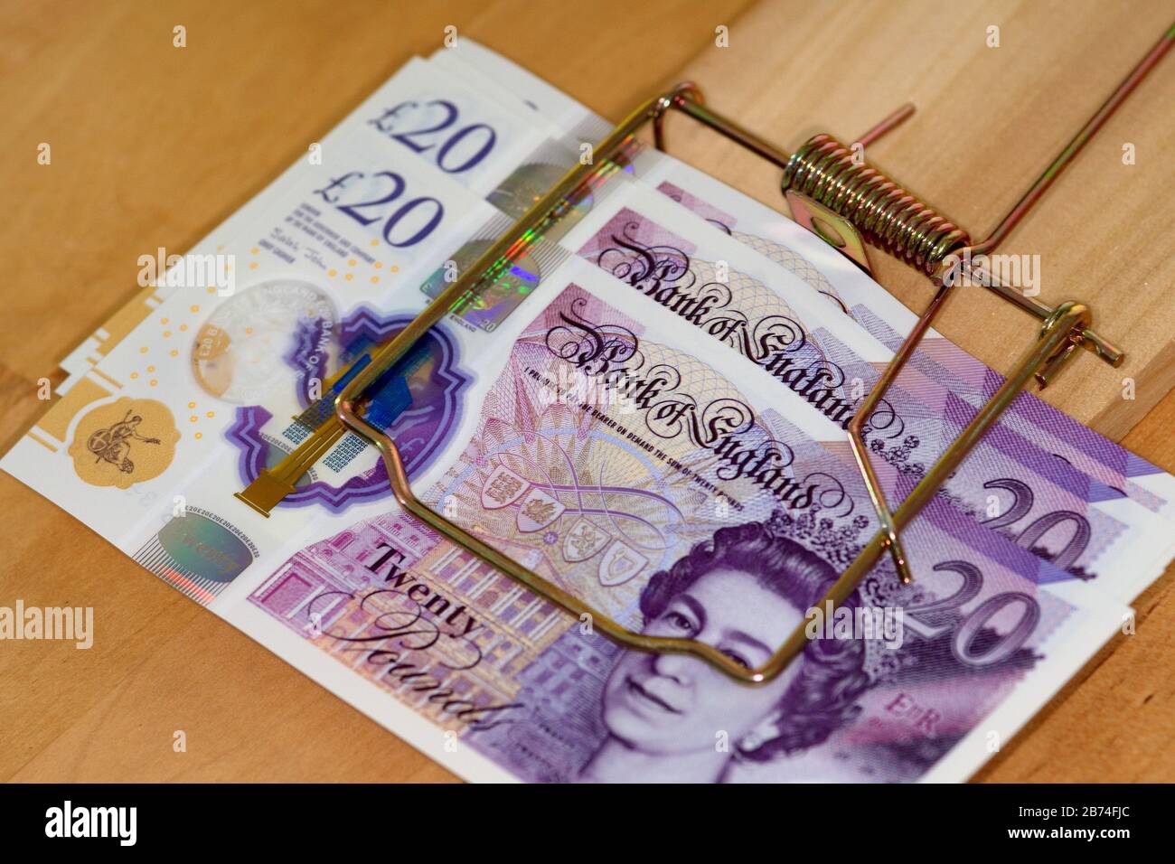 uk twenty pound notes trapped in mousetrap Stock Photo - Alamy