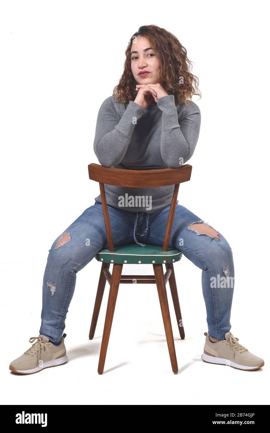 portrait of a woman sitting on a chair in white background, rear view ...