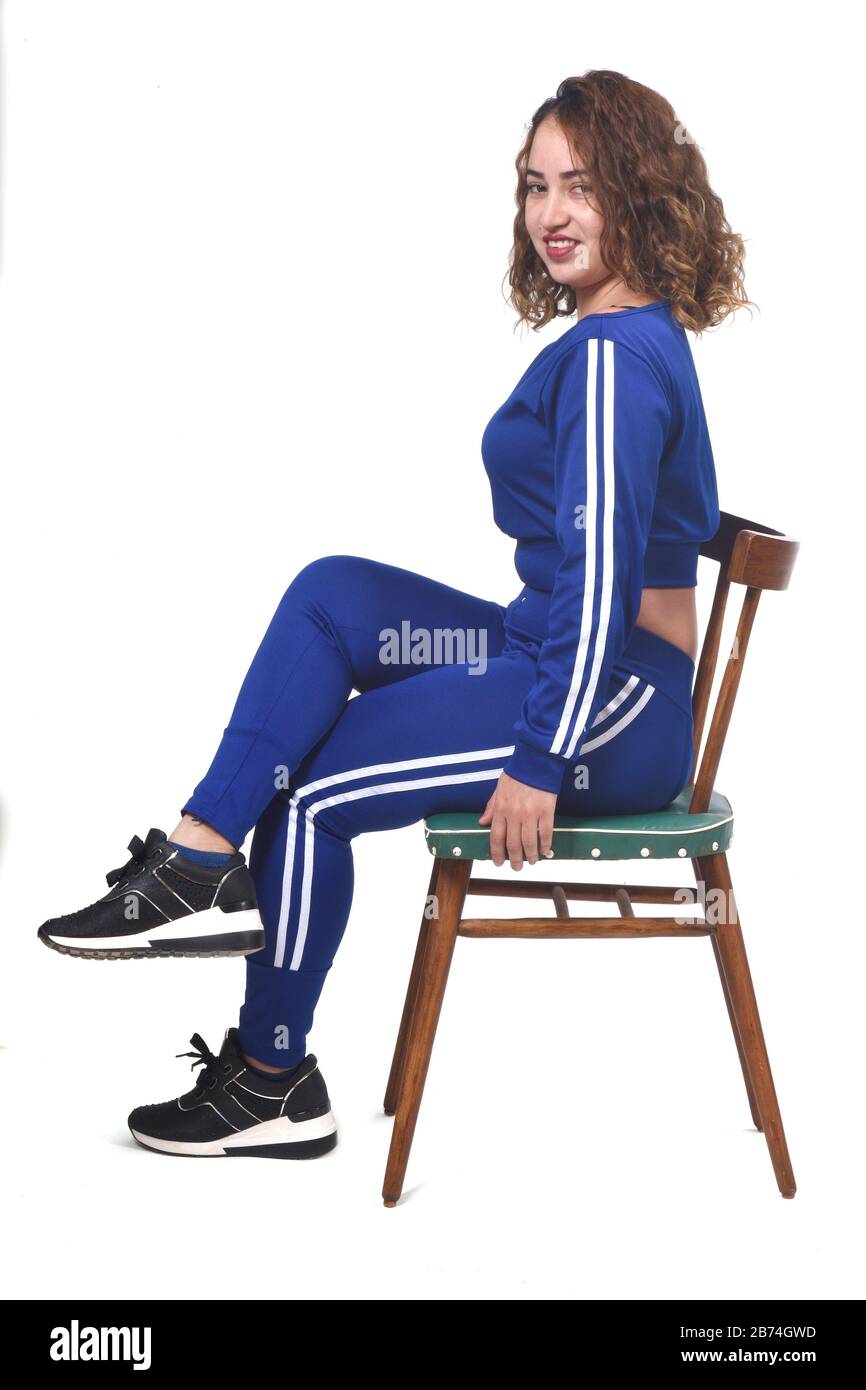 portrait of a woman sitting on a chair in white background,looking at ...