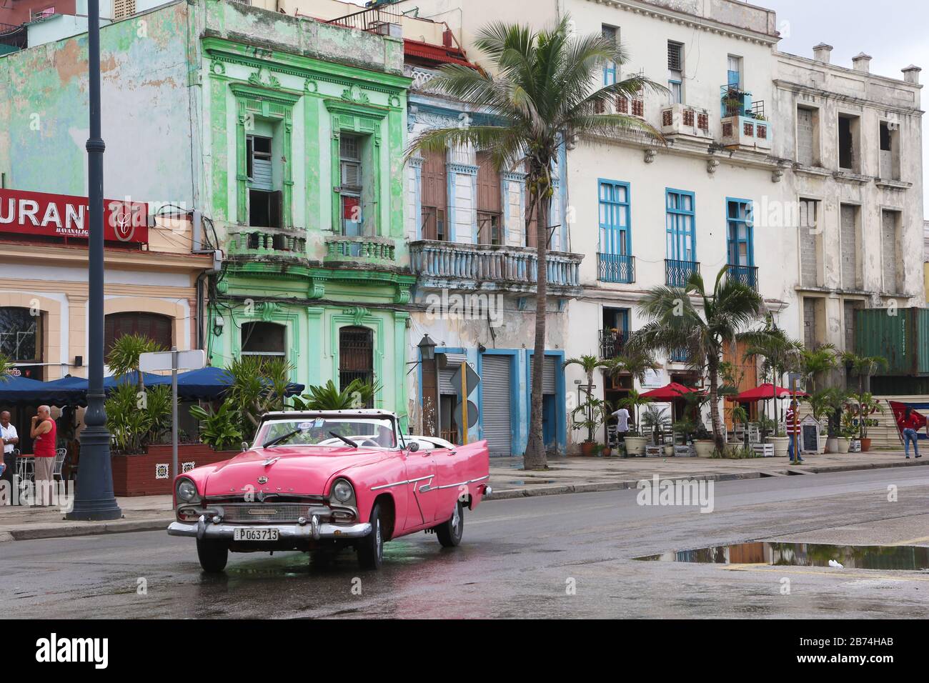 Havana, Cuba - Pink classic car in front of old colonial buildings ...