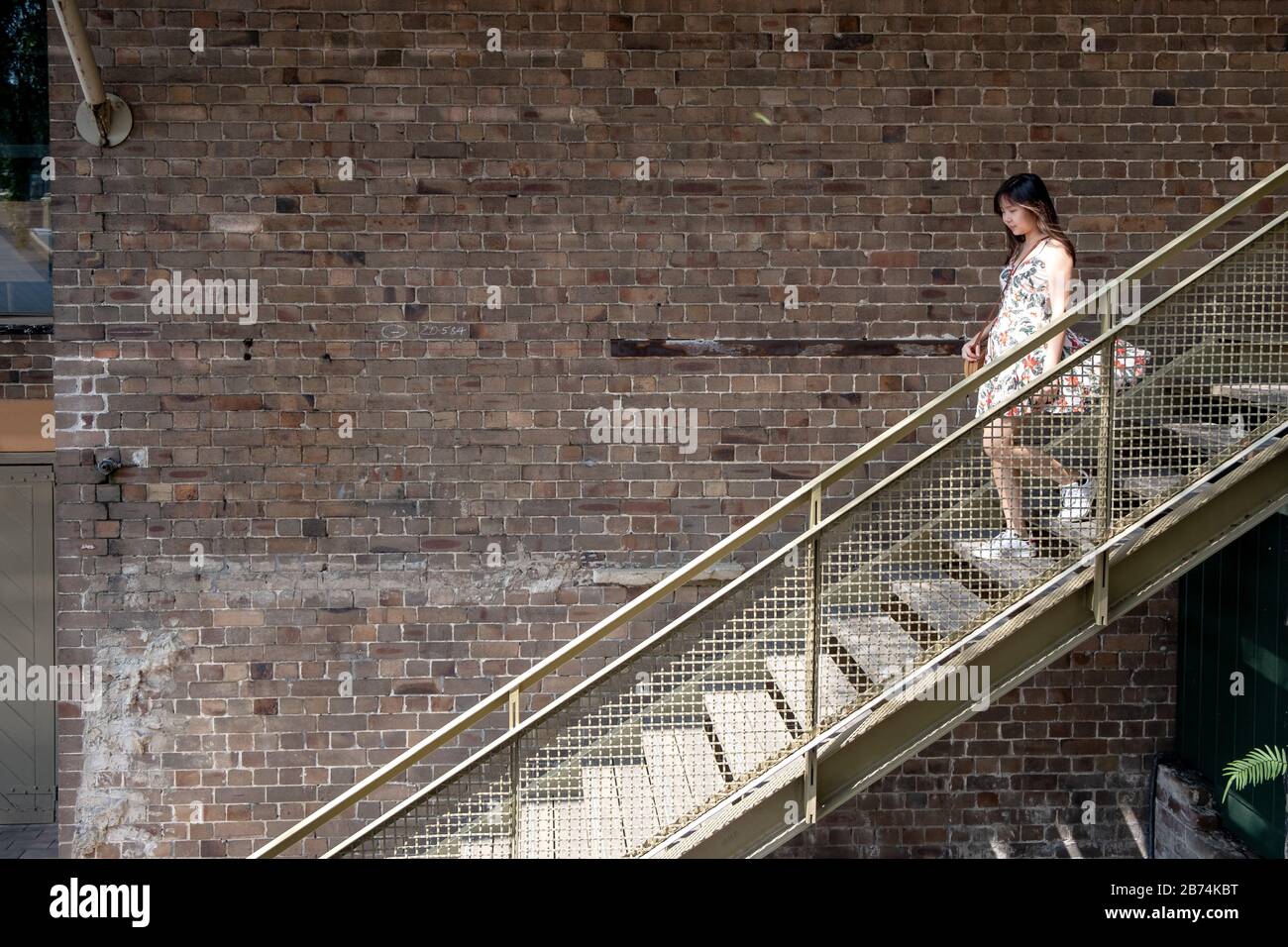 Single female Asian climb staircase beside brick wall Stock Photo - Alamy