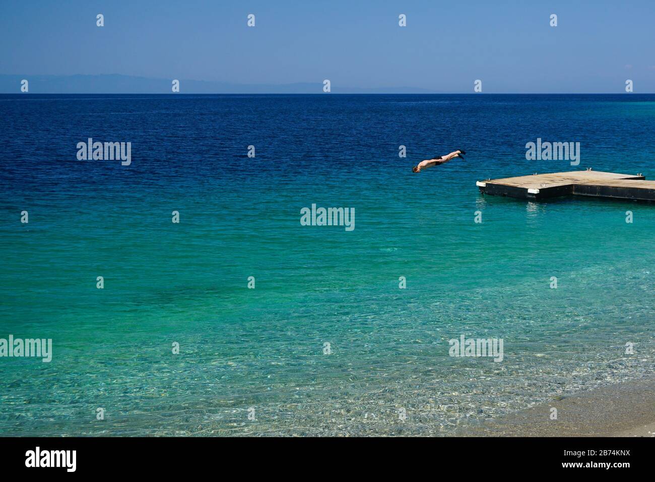 Man diving head first into the ocean from the dock Stock Photo - Alamy