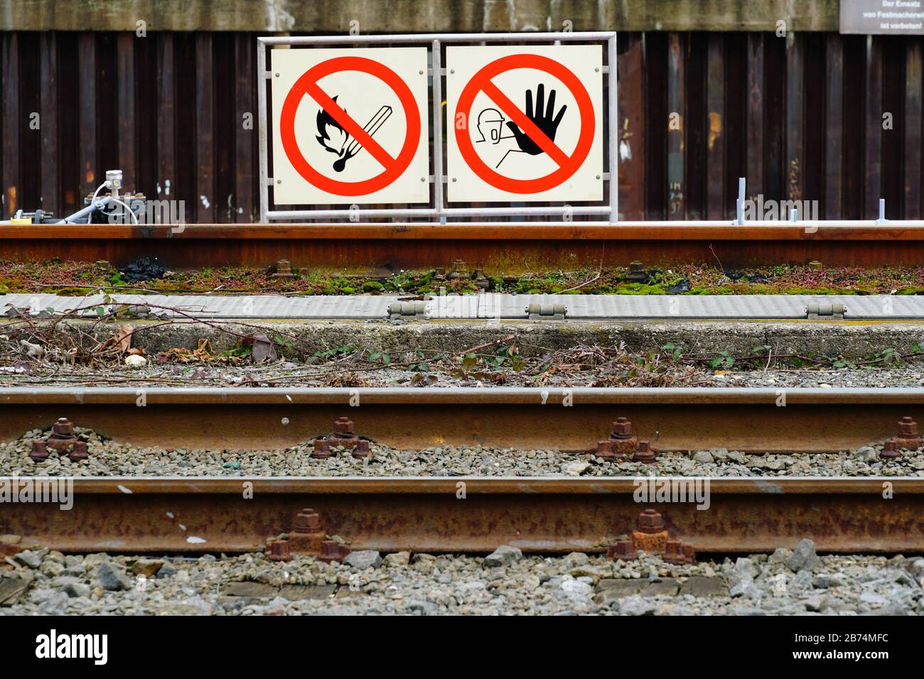 Warning signs in the railway station near the rails Stock Photo - Alamy