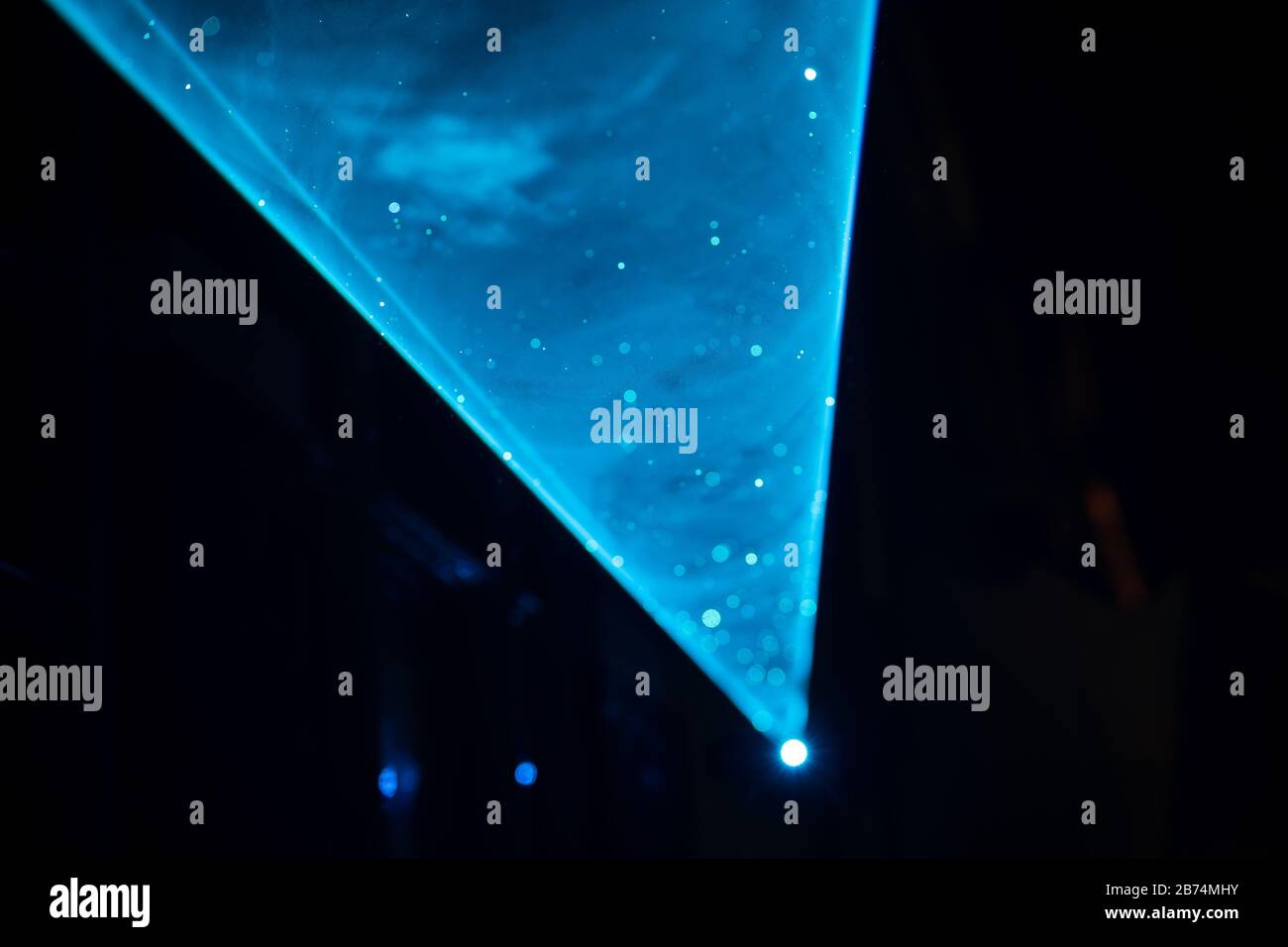 Beam of blue light against a dark background Stock Photo - Alamy