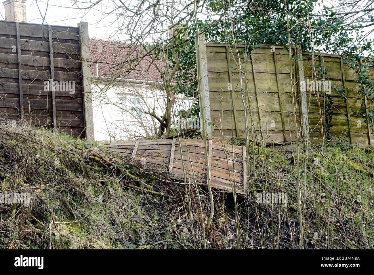 A fencing panel blown out of its supports Stock Photo - Alamy