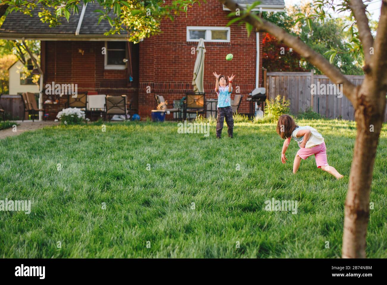 Children throw ball hi-res stock photography and images - Alamy