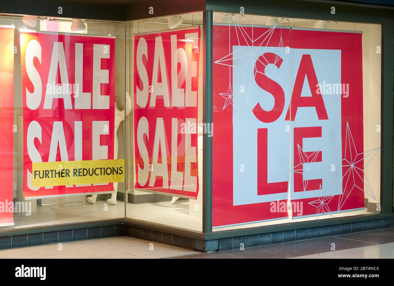 Closing down sale sign with further reductions and discount in shop ...