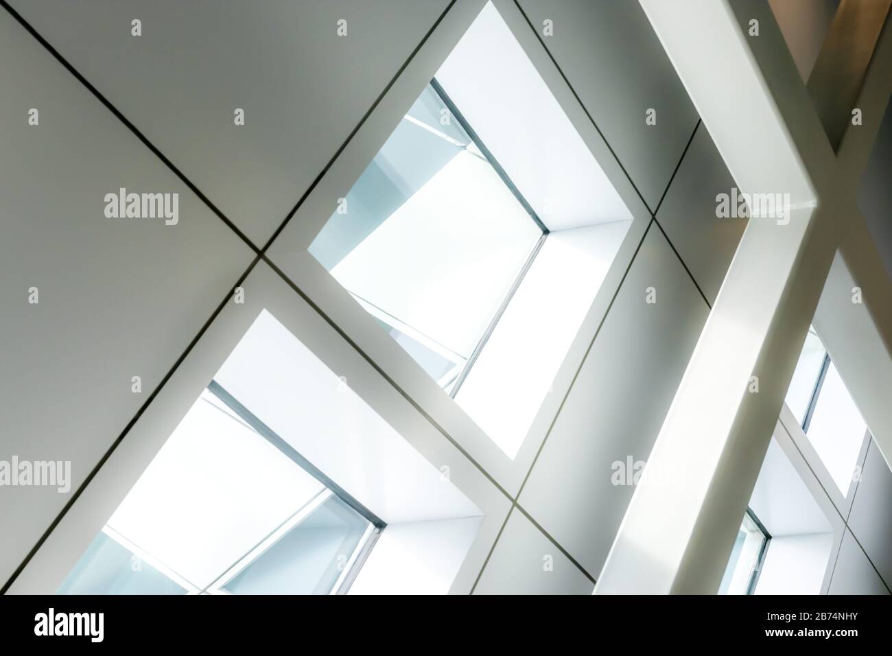 Low angle shot of square windows on the white wall of a modern building ...