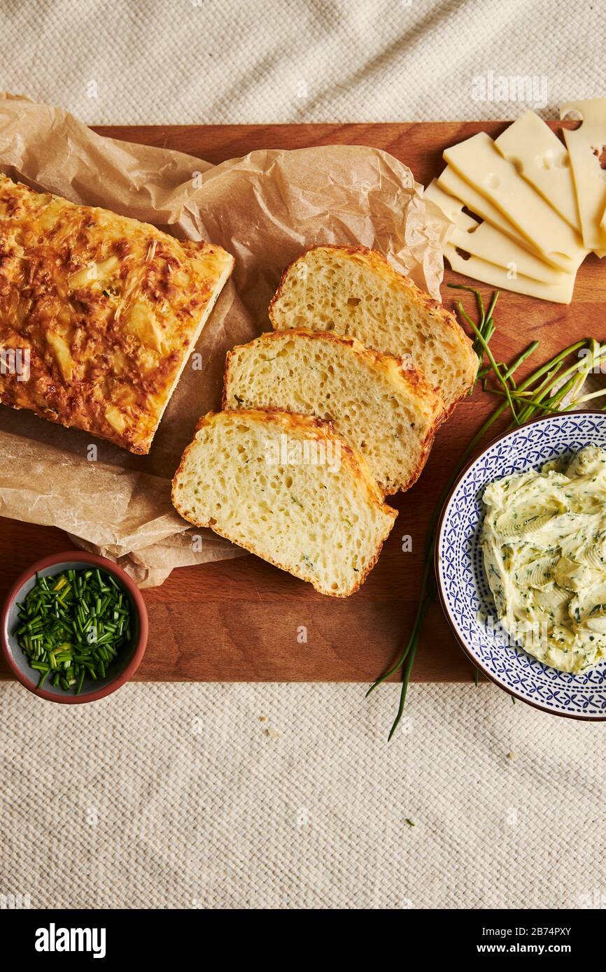 Vertical shot of bread with cheese herbal butter on a wood Stock Photo ...