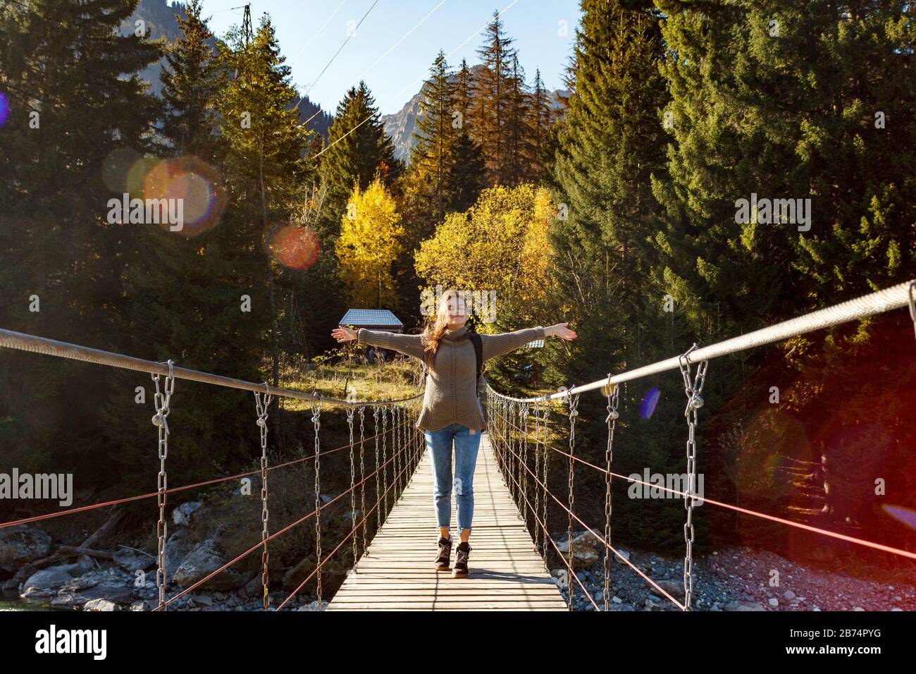 Girl on suspension bridge hi-res stock photography and images - Alamy