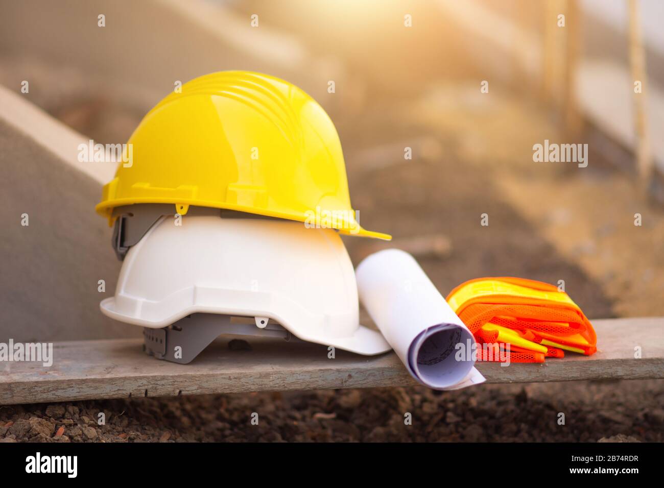 Hard hat on wooden board and blueprint building construction estate ...