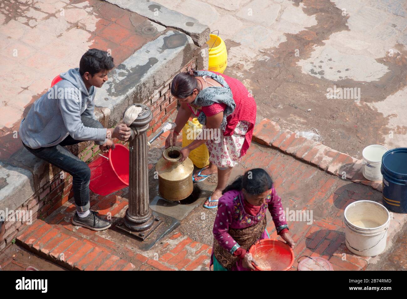 Woman pumping water borehole hi-res stock photography and images - Alamy