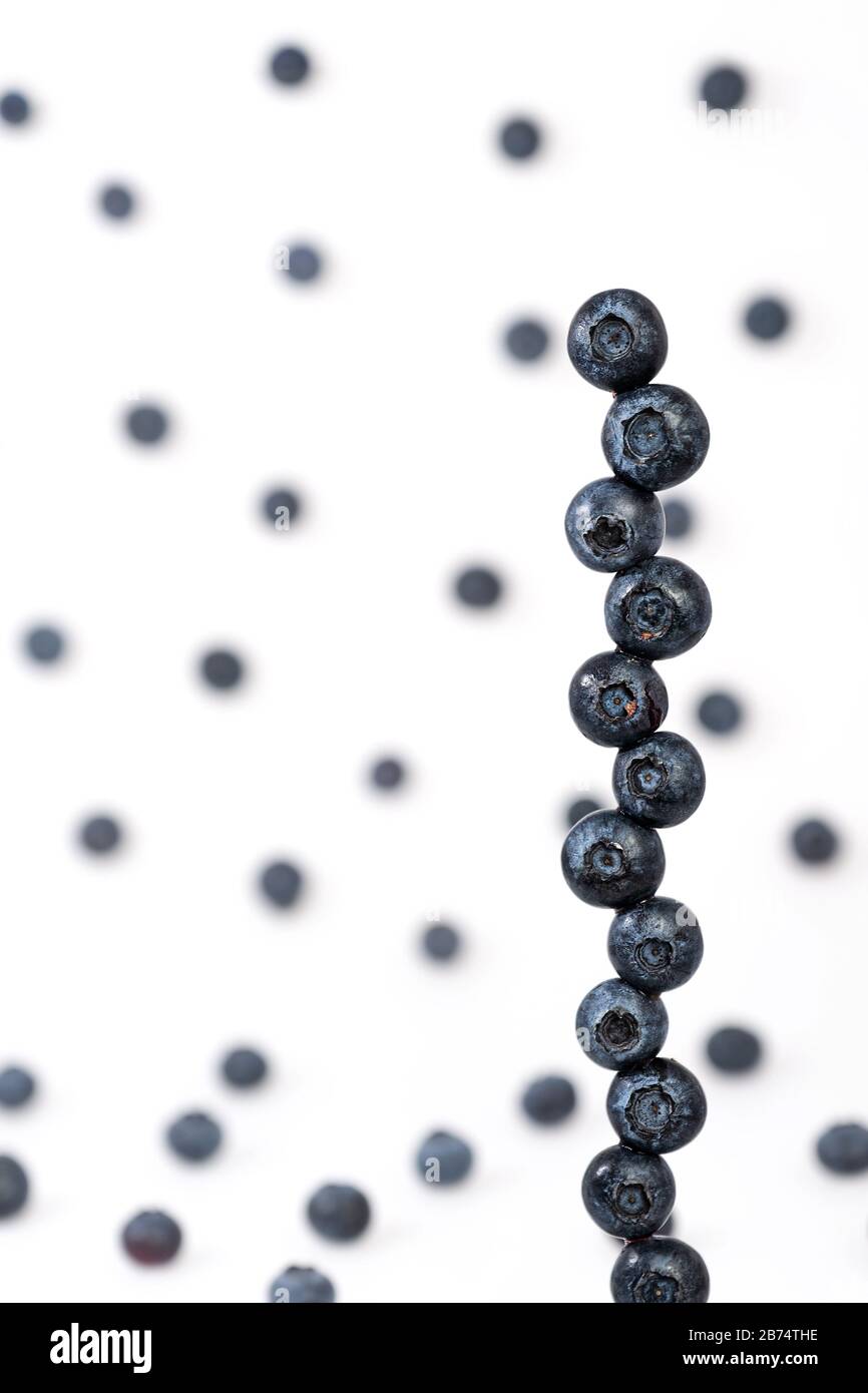 blueberries stacked on top of each other, many blurred in the ...