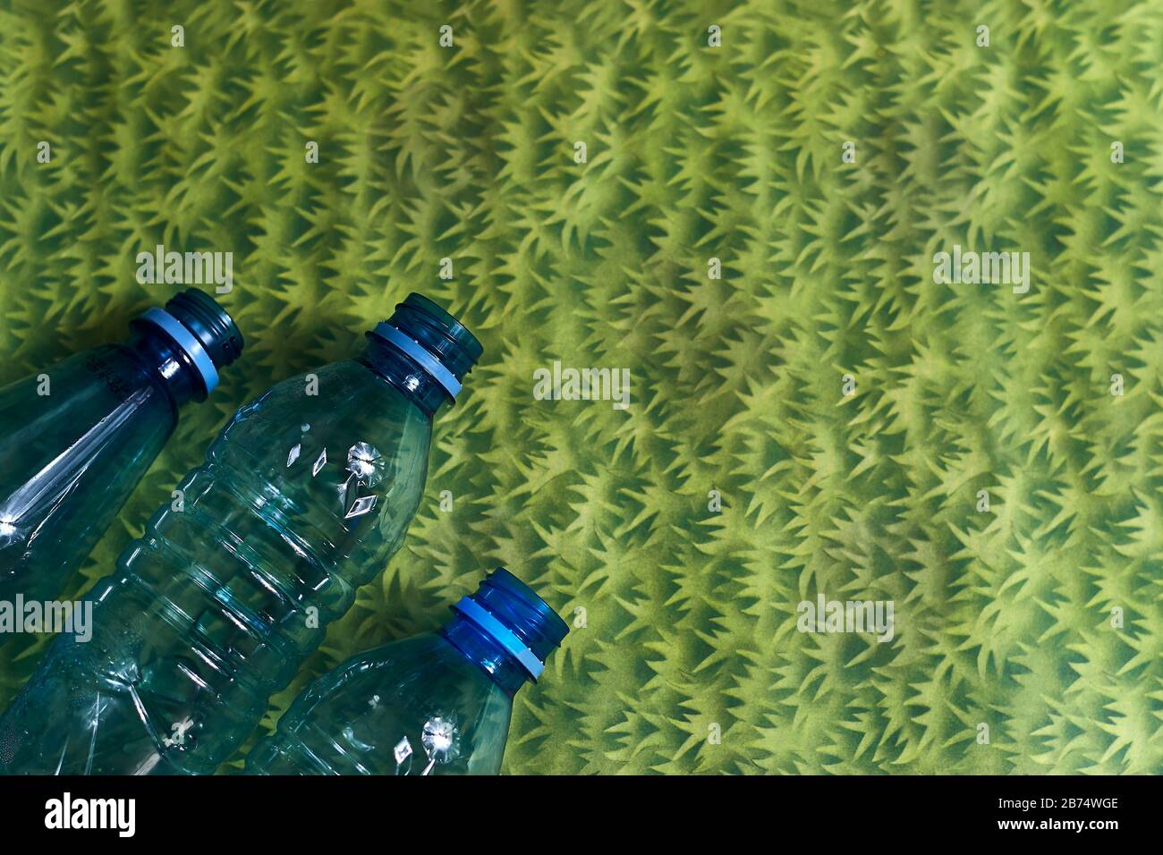 Plastic bottles on the floor with green leaves-plastic pollution Stock ...