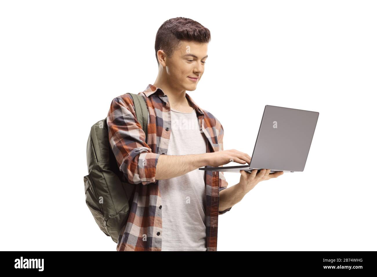 Student standing and using a laptop computer isolated on white ...