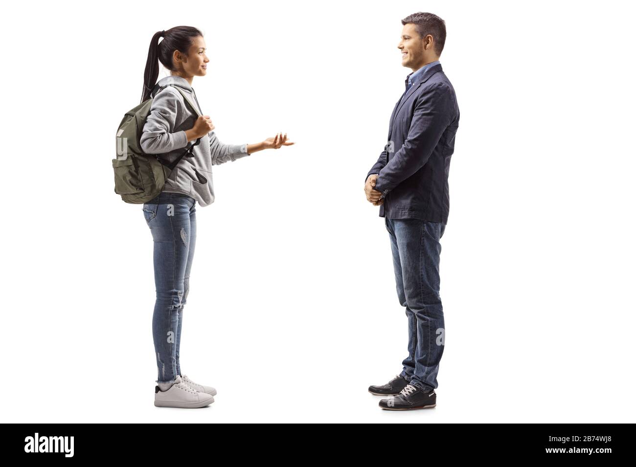 Full length profile shot of a female student talking to a young man ...