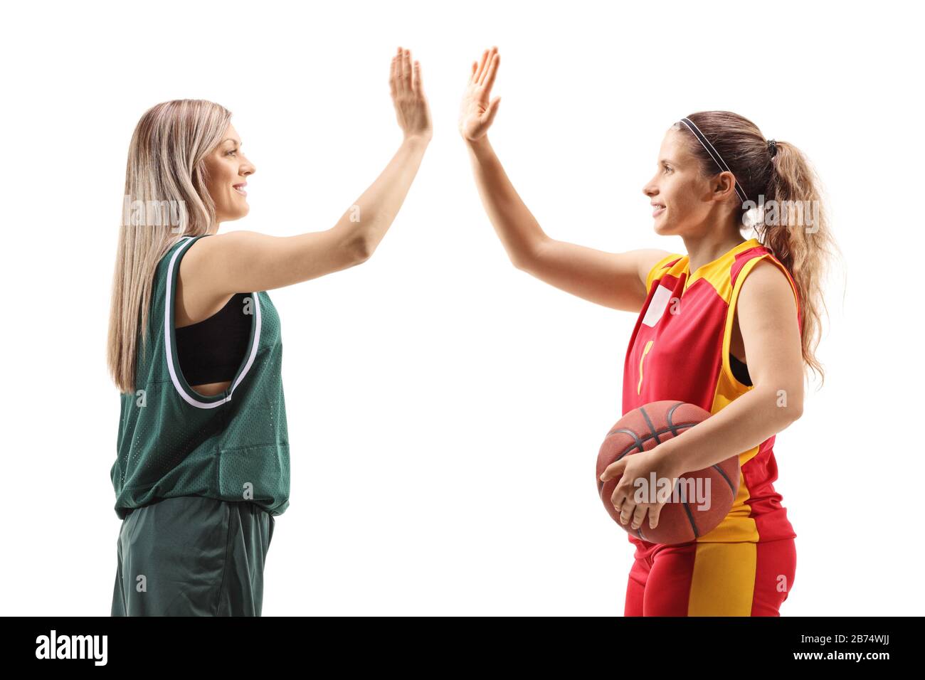 Female basketball players gesturing high-five isolated on white ...