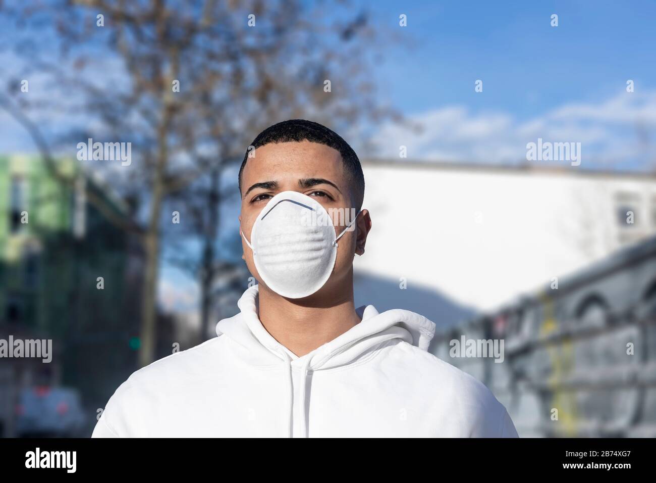 Sick man wearing protective facial mask against transmissible ...